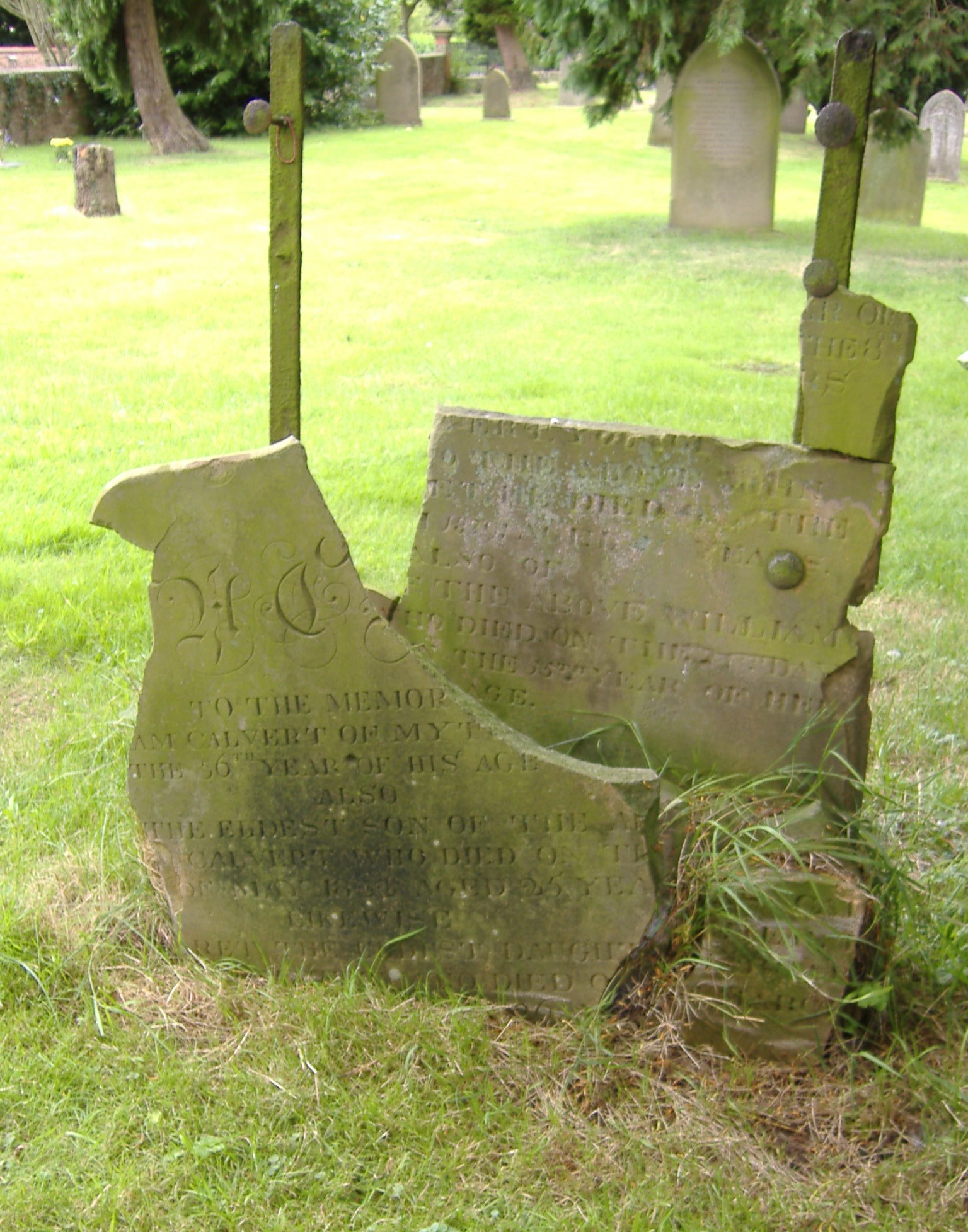Broken gravestone in several pieces.